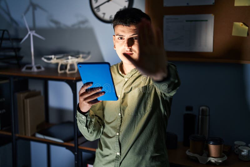 Non Binary Person Using Touchpad Device at Night Doing Stop Sing with ...