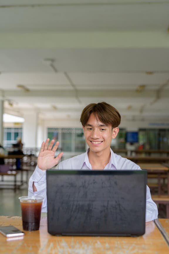 Non Binary University Student Sitting in College Campus Using Laptop ...