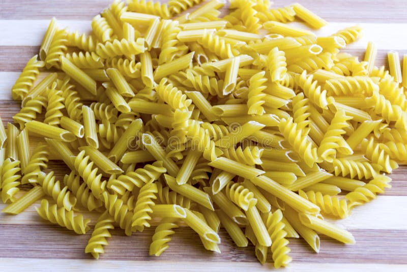 Noodles of Different Shapes of Yellow Color Lie on the Table. Stock ... Noodles of Different Shapes of Yellow Color Lie on the Table. Stock ...
