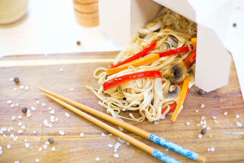 Noodles with Pork and Vegetables in Take-out Box on Wooden Table Stock ...