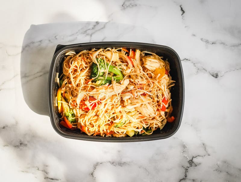 Noodles with Vegetables in a Container on the Table. Stock Photo ...