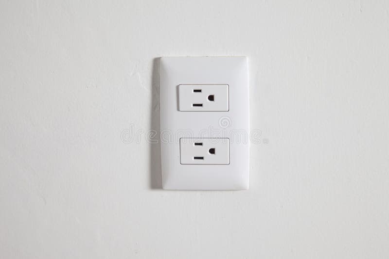 North American Power Outlet Plug in Socket on a White Wall Background ...