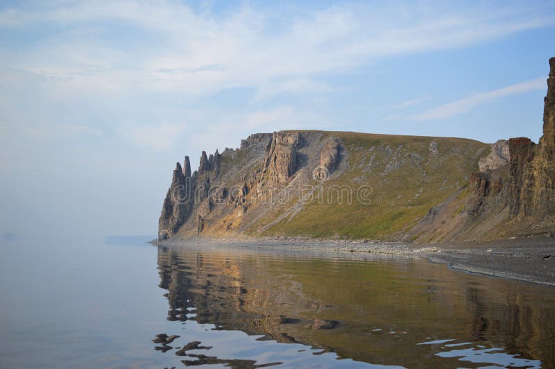 North Cliff Reflecting in Water Stock Photo - Image of rock, ocean ...