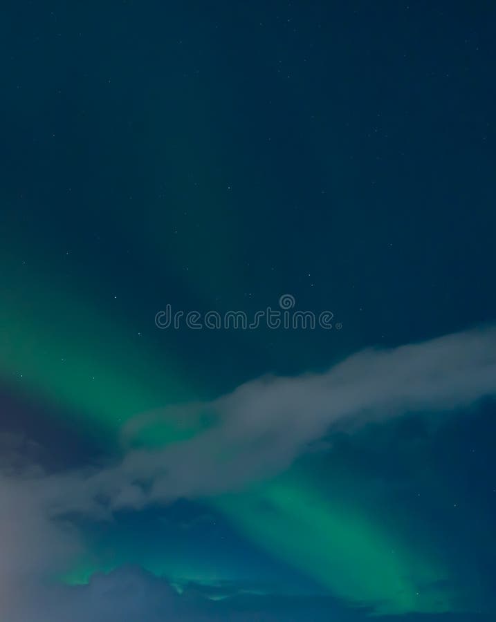 Northern Lights with Clouds Illuminated by the Full Moon with a Starry and Bluish Sky in Iceland ...