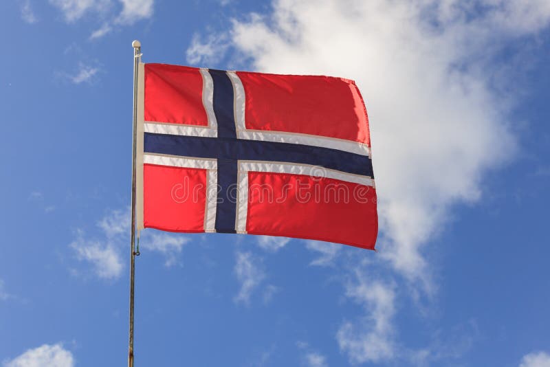The Norwegian Flag Against Blue Sky Stock Image - Image of national ...
