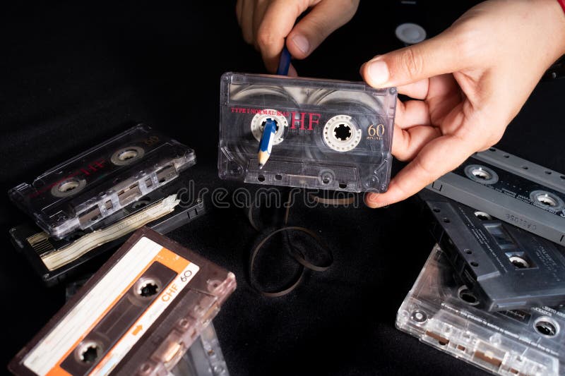 Person Using a Pencil To Wind the Tape of a Retro Cassette Stock Image ...