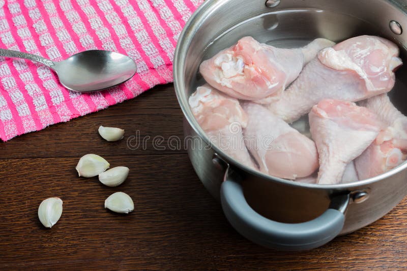 Not Cooked Chicken Leg and Garlic Cloves in a Metal Pan Stock Photo ...