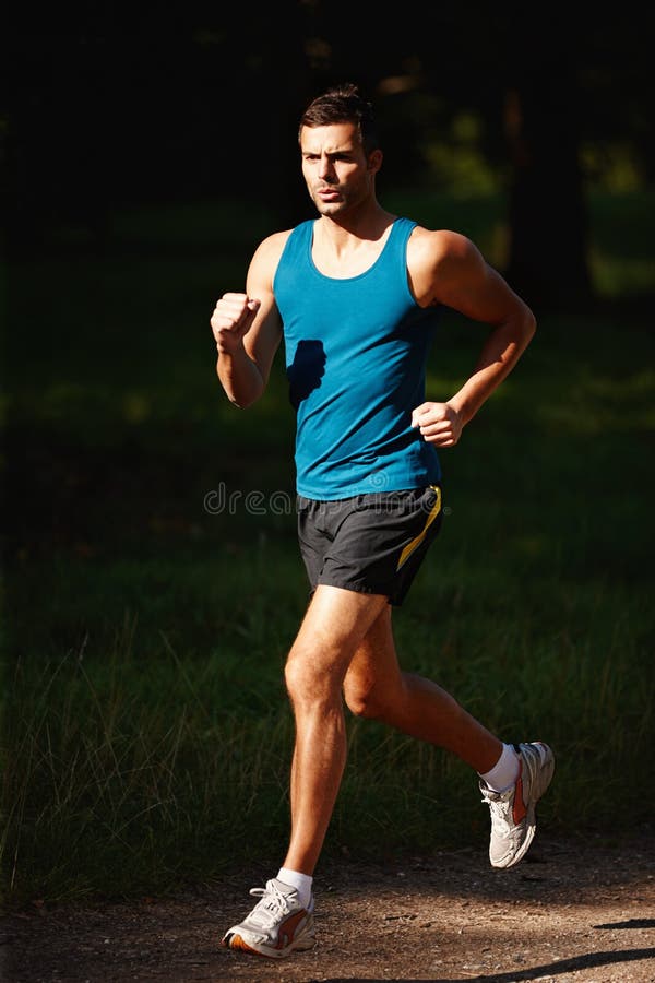 Not Even a Drop of Sweat. Shot of a Handsome Young Man Taking a Jog ...