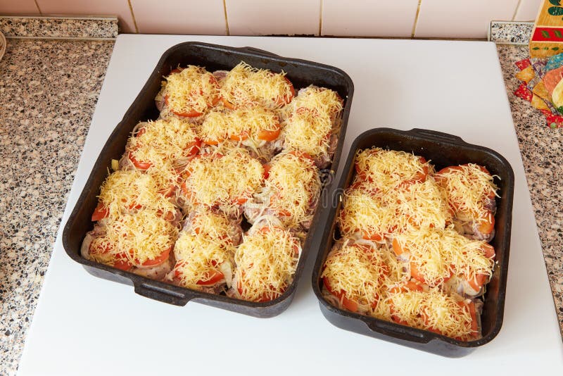 Not Fried Meat with Tomatoes and Cheese on Two Frying Pans Stock Photo ...
