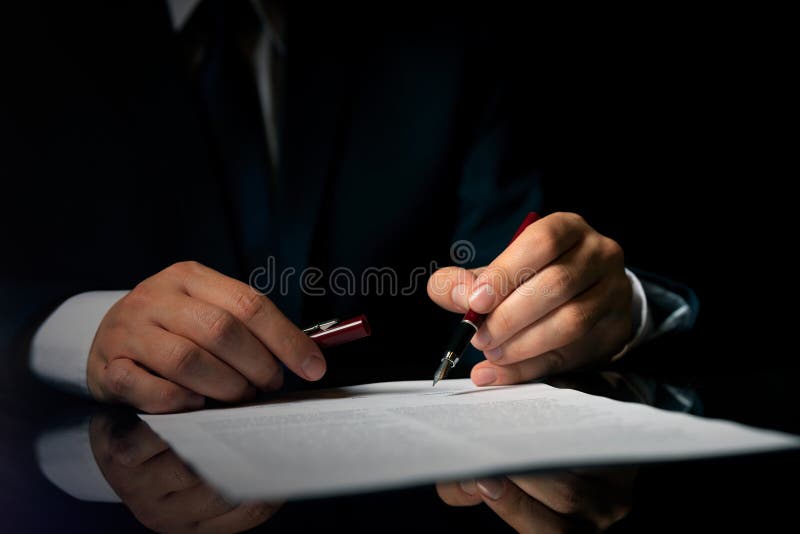 Notary Signing a Contract with Fountain Pen in Dark Room Stock Photo ...