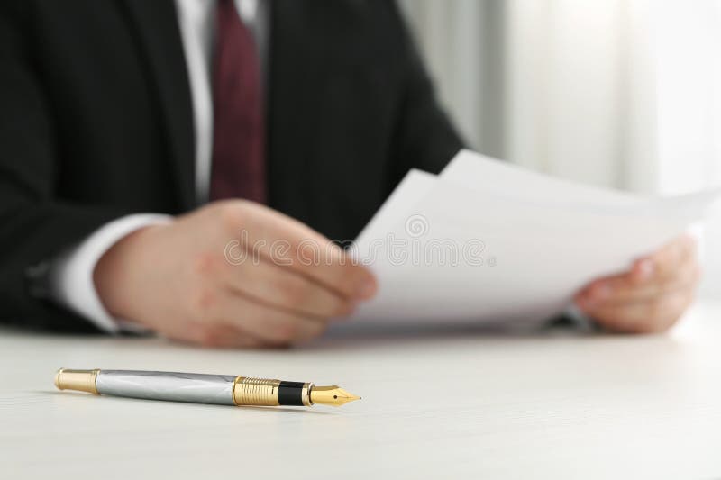 Notary Reading Documents at Wooden Table, Focus on Fountain Pen Stock ...
