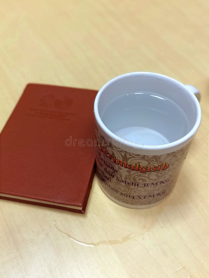 Note Book and a Cup of Water on the Floor Stock Image - Image of floor ...