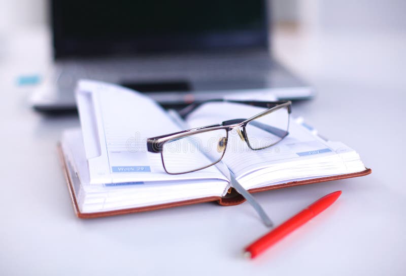 A Note Book, Laptop, Pen, Graph Paper Document on the Office Desk Table ...