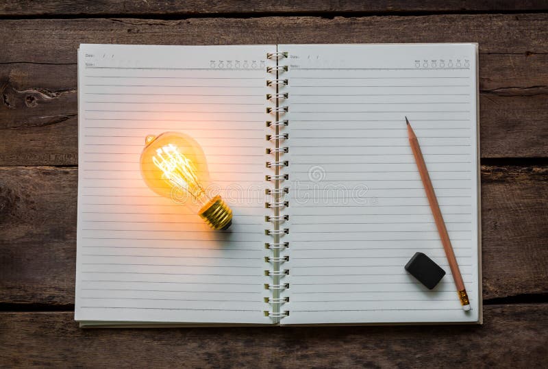 Note book and light bulb stock image. Image of close - 45996617
