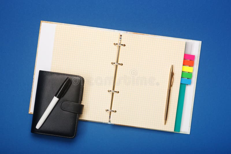 Note Book with Marker and Pen on a Blue Background Stock Photo - Image ...