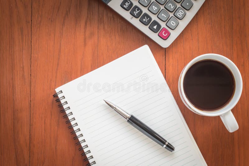 Note Book with Pen and a Cup of Coffee on Wood Table. Stock Photo ...