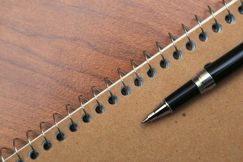 Note book and pen on desk stock photo. Image of book - 43345670