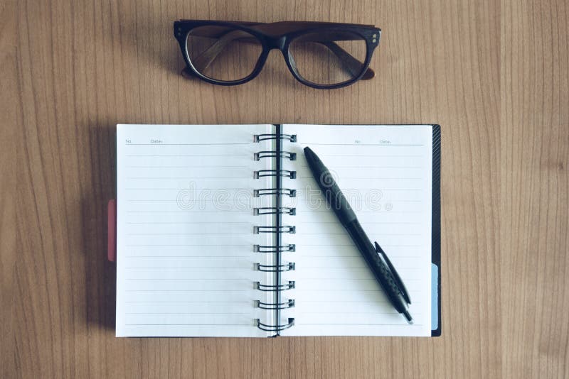 Top View on a Note Book with Pen and Glasses on a Workdesk Stock Image ...