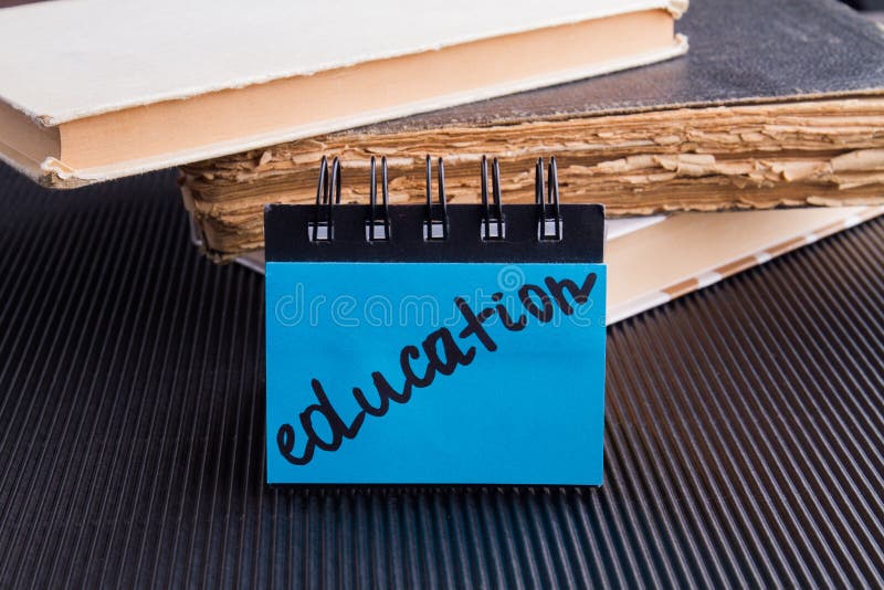Note Book with Word Education on the Paper and Stack of Old Books ...