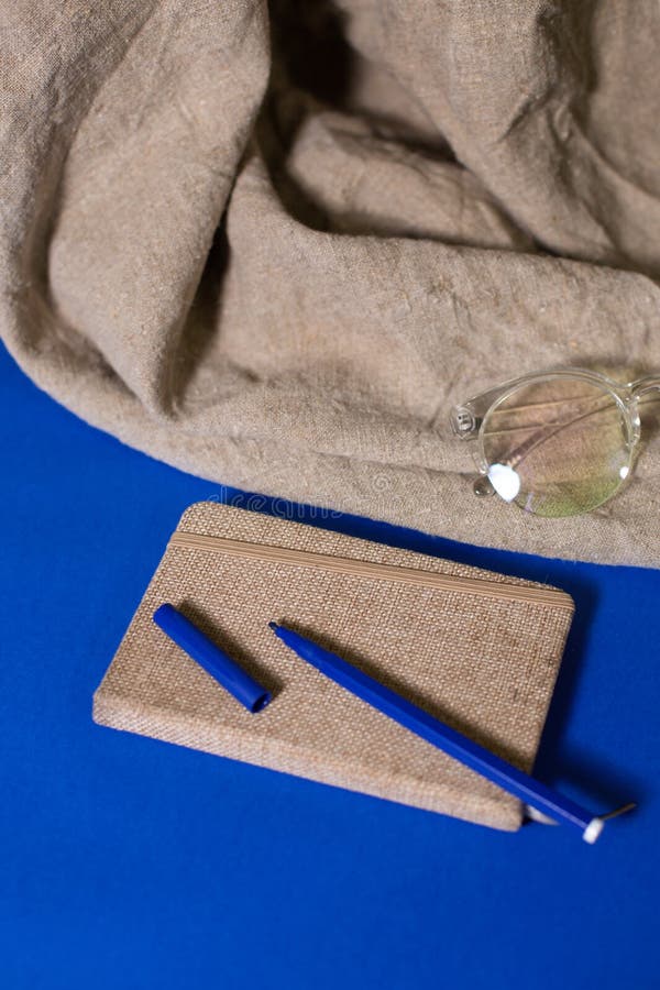Notebook in a Burlap Cover with a Blue Felt-tip Pen and Glasses Near ...