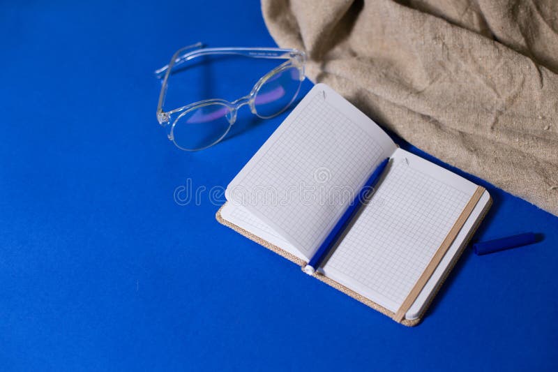 Notebook in a Burlap Cover with a Blue Felt-tip Pen and Glasses Near ...