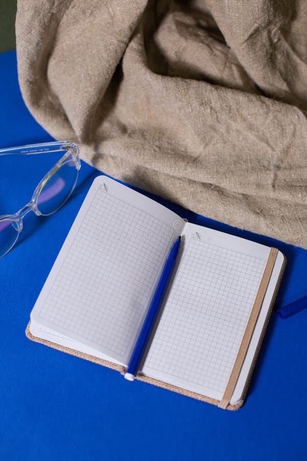 Notebook in a Burlap Cover with a Blue Felt-tip Pen and Glasses Near ...