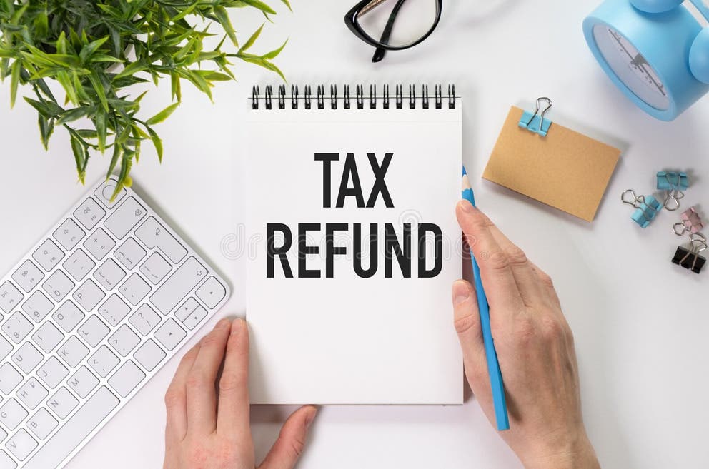 Notebook with a Business Notes TAX REFUND on the Office Table with ...