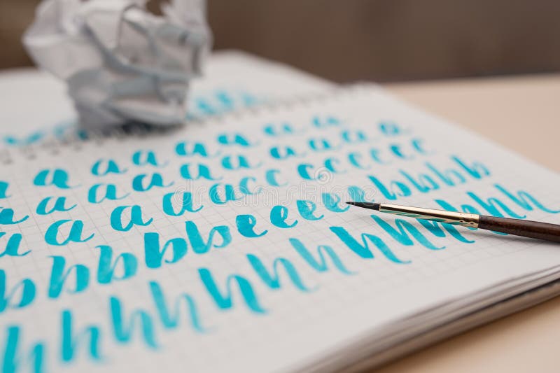 Notebook with Calligraphy Lettering and Brush Stock Photo - Image of ...