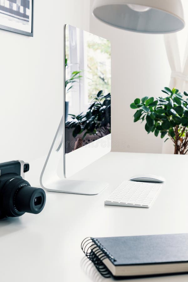 Camera and Desktop Computer on White Desk with Lamp in Freelancer`s ...