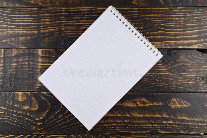 Notebook with Cells on a Wooden Background. Empty Notebook on Wooden ...
