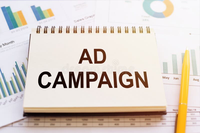 Notebook with Charts and Pen and Notes about Ad Campaign Stock Photo ...