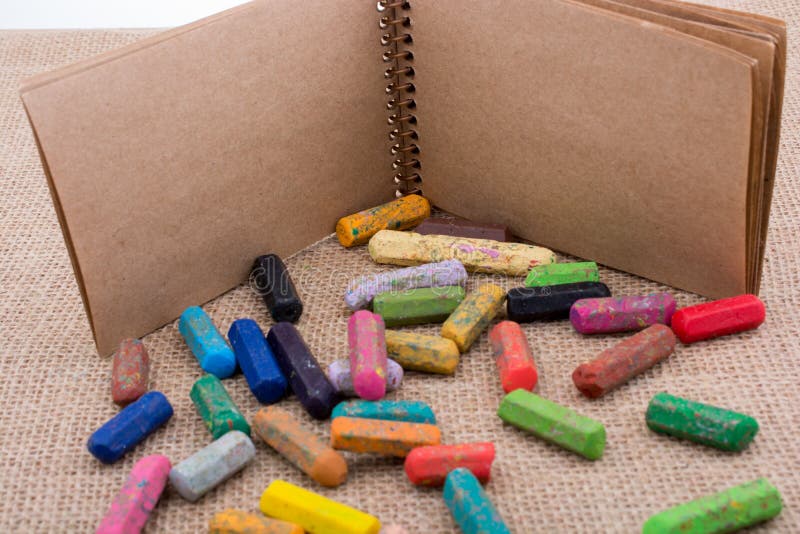 Notebook beside Colorful Crayons Stock Image - Image of shaped ...