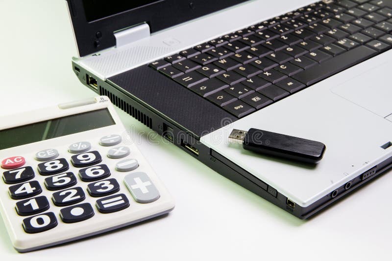 Notebook Computer on the Desk.Calculators,USB Flash Drive Stick Stock ...