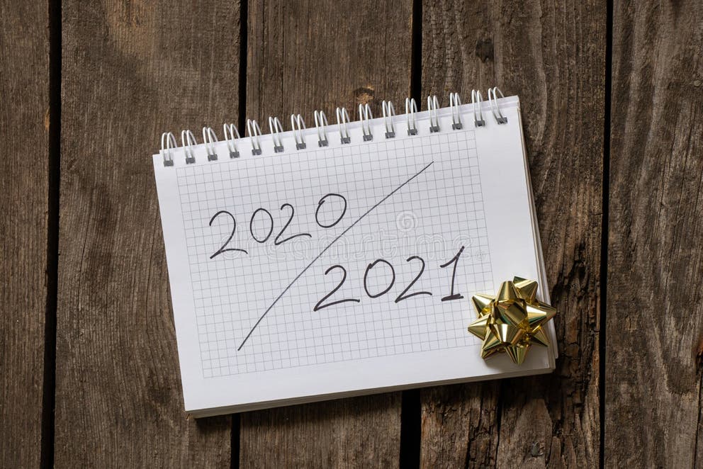 The Notebook is Divided into Two Columns 2020 and 2021 on a Wooden ...