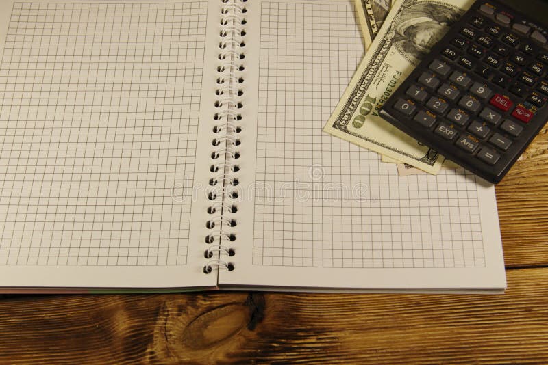Notebook with Dollars and Calculator on Wooden Desk Stock Photo - Image ...