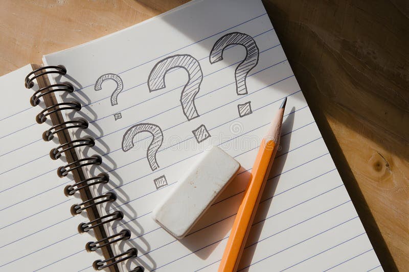 Notebook with Drawn Question Marks, Pencil, and Shadows on a Wooden ...