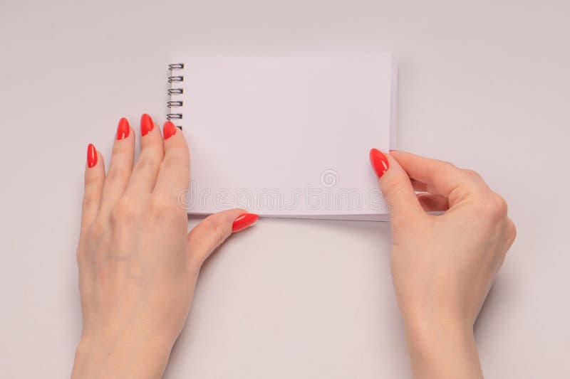 A Notebook with Empty White Paper in Woman Hands with Red Nails Stock ...