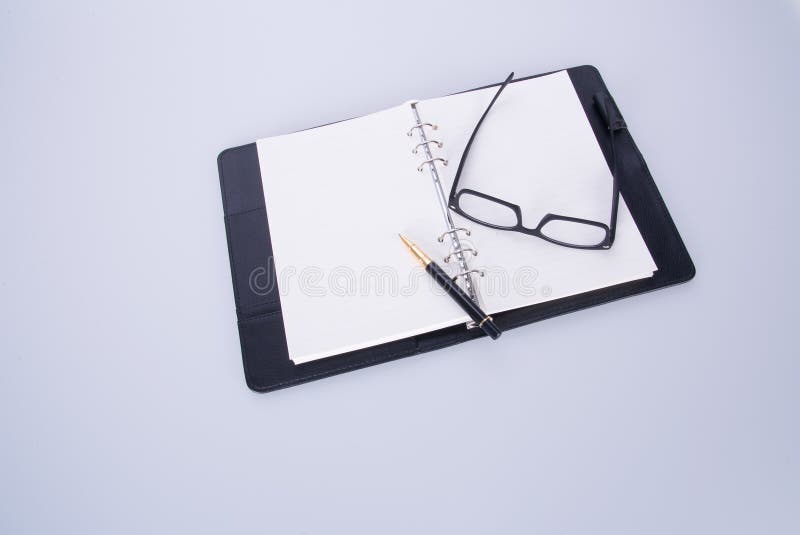 Notebook with Glasses and Pen on the Blackground. Stock Photo - Image ...
