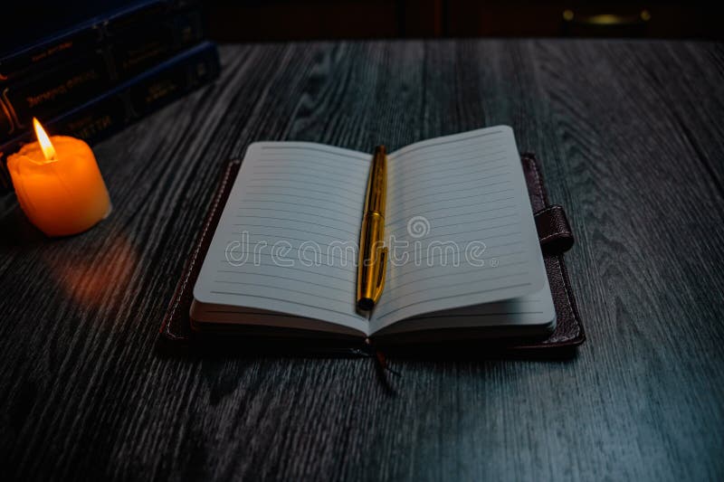 A Notebook with a Gold Pen on the Table in the Candlelight Stock Image ...