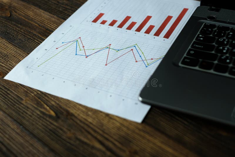 Notebook Laptop Computer and Financial Graph on White Paper on W Stock ...