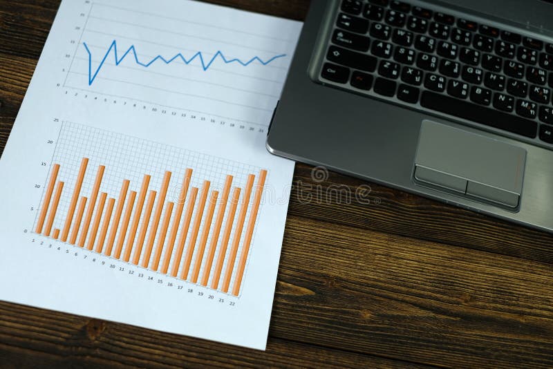 Notebook Laptop Computer and Financial Graph on White Paper on W Stock ...