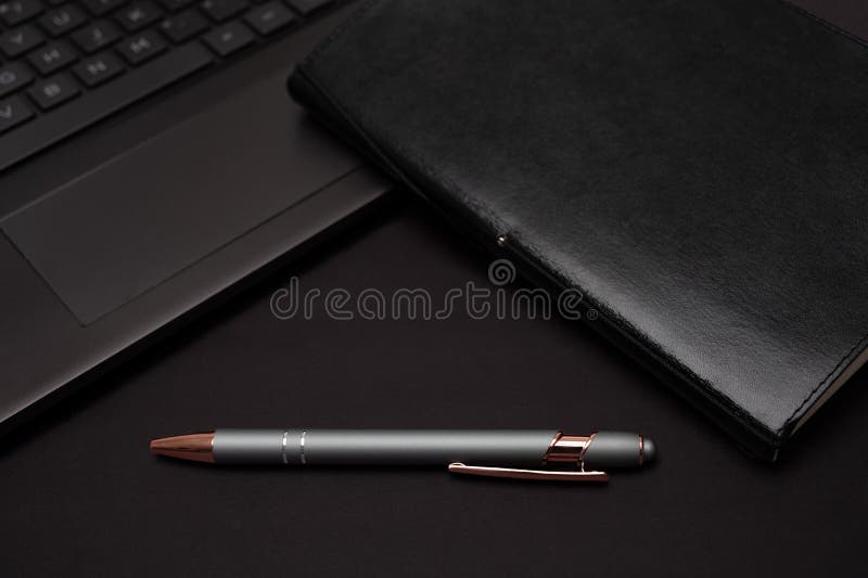 Notebook, Laptop, and Silver Pen on a Black Table Stock Photo - Image ...