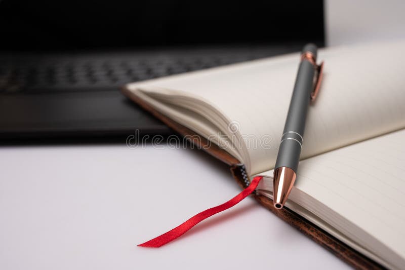Notebook, Laptop, and Silver Pen on a Rustic Notebook Stock Photo ...