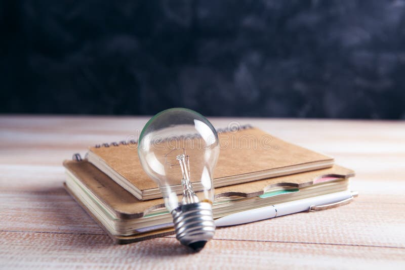 Notebook and Light Bulb on the Table Stock Photo - Image of creative ...