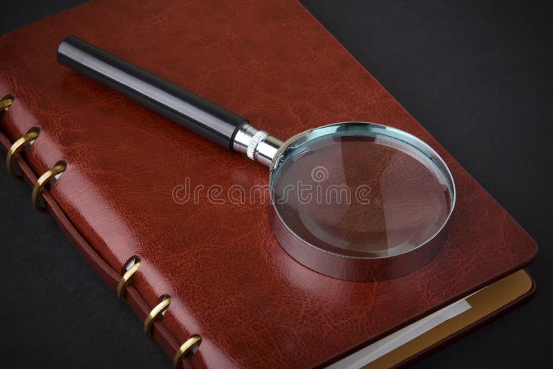 Notebook with a magnifier stock photo. Image of magnifier - 23986262