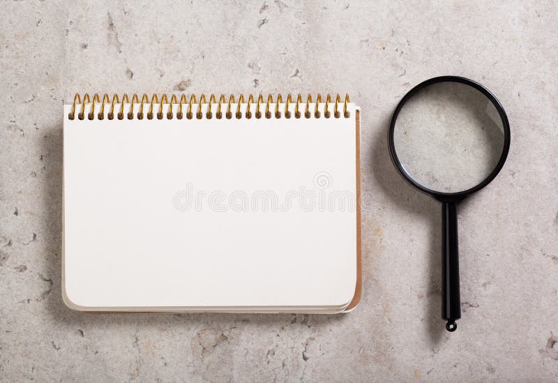 Notebook and magnifier stock image. Image of checked - 77806541
