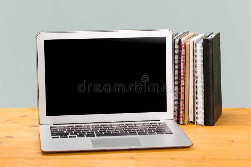 Notebook with Multi-colored Books on a Wooden Table. Mocap. Work from ...
