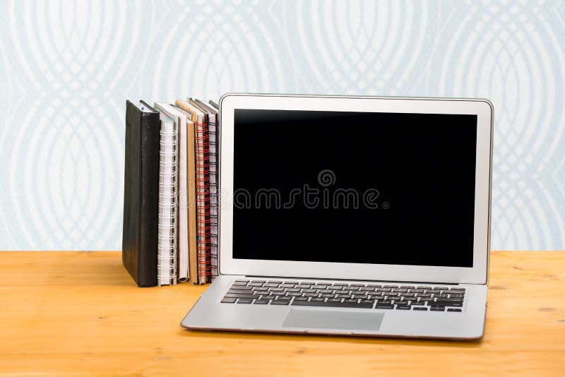 Notebook with Multi-colored Books on a Wooden Table. Mocap. Work from ...