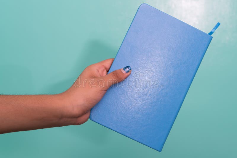 Notebook on a Hand the Color Blue at Studio Stock Photo - Image of task ...