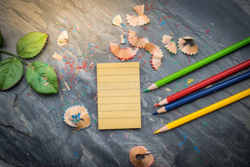 A Notebook for Notes with Crayons and Pencils. Pencil Sharpener Placed ...